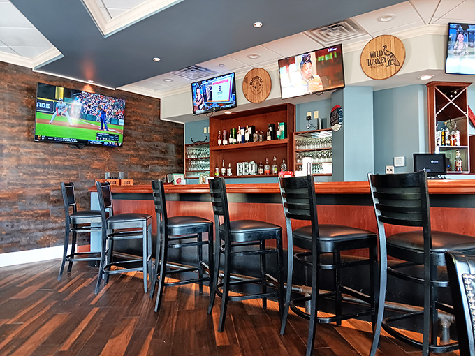 A bar built for lingering, where local brews flow and BBQ debates flourish. Those wooden barrel medallions on the wall aren't just decor—they're conversation starters.