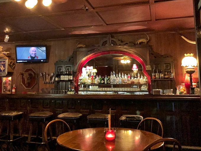 A bar that beckons with amber lighting and the promise of perfectly mixed drinks. That red glow isn't just ambiance&mdash;it's an invitation.