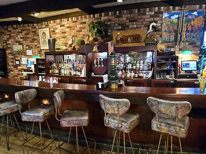 A bar stocked for sailors and landlubbers alike, where stories flow as freely as the drinks beneath the warm glow of pendant lights.