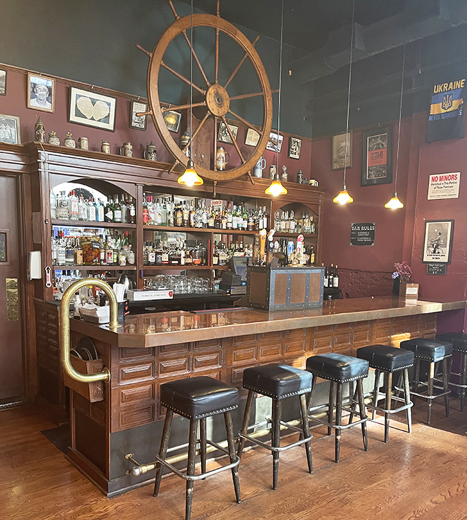 The bar area feels like the captain's quarters of a particularly well-stocked ship, where maritime adventures begin with a perfectly mixed cocktail.