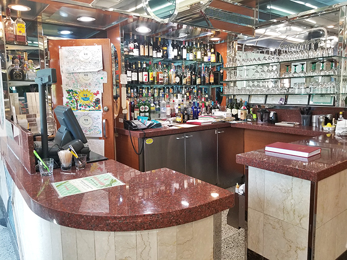 The bar area sparkles with promise, where evening patrons can transition from coffee to cocktails without changing their zip code.