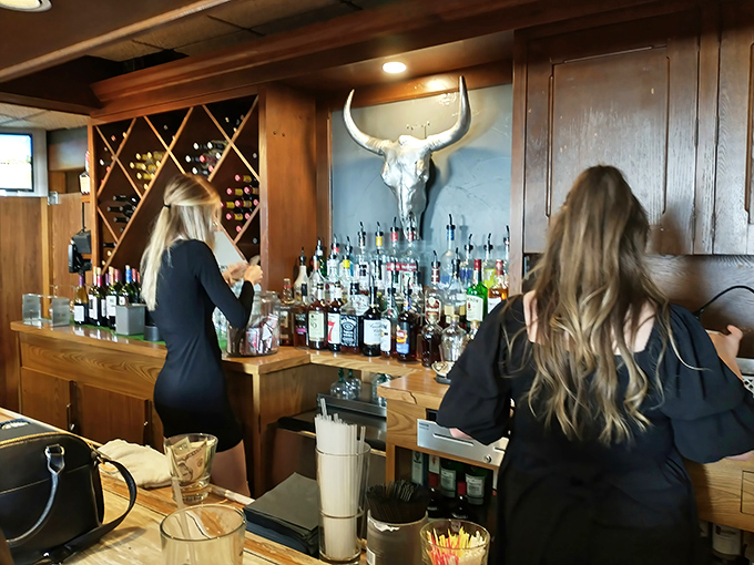 A longhorn skull watches over bottles of liquid courage. This bar setup isn't just functional&mdash;it's a shrine to Wisconsin's cocktail culture.