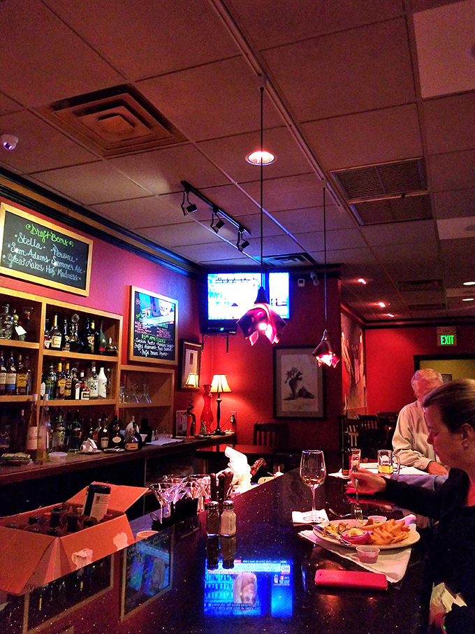 The bar area glows with that perfect lighting that makes everyone look like they've just returned from an Italian vacation.