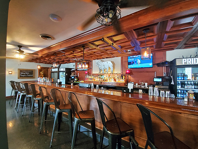 Warm wood, corrugated metal, and pendant lighting create a bar area that feels both sophisticated and completely unpretentious – just like great barbecue should be.