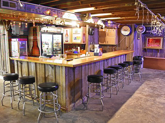 The rustic basement bar area feels like the coolest friend's garage—if that friend happened to serve perfect drinks and had great taste in neon signs.