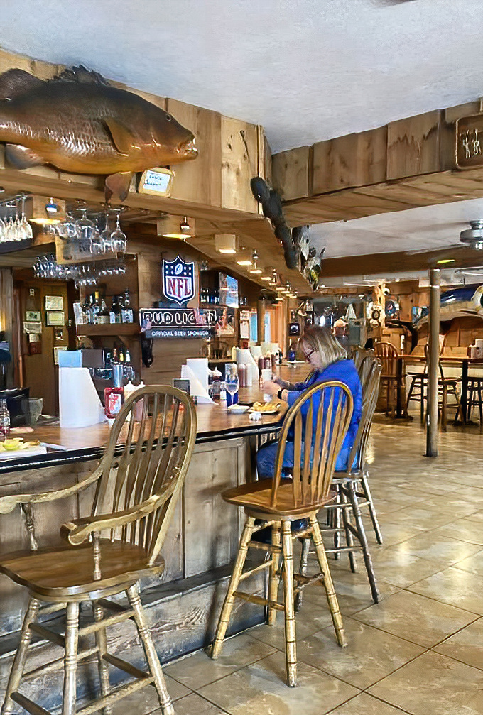 Where the regulars perch at the bar, trading fish tales that grow taller with each cold beer. The mounted fish aren't buying it.