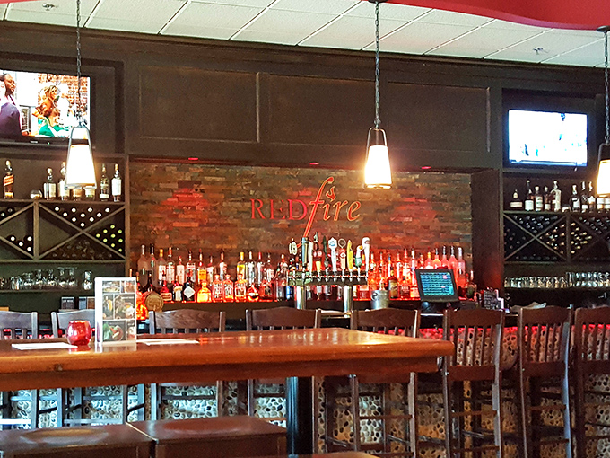 The bar area glows with amber promise, like a lighthouse guiding hungry sailors toward the shores of proper Manhattan cocktails and local craft beers.