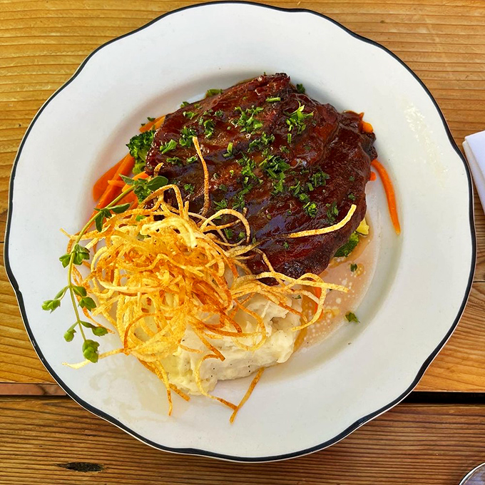 Brisket so tender it makes you wonder if they've discovered some secret law of physics. That crispy garnish adds textural counterpoint to meat symphony.