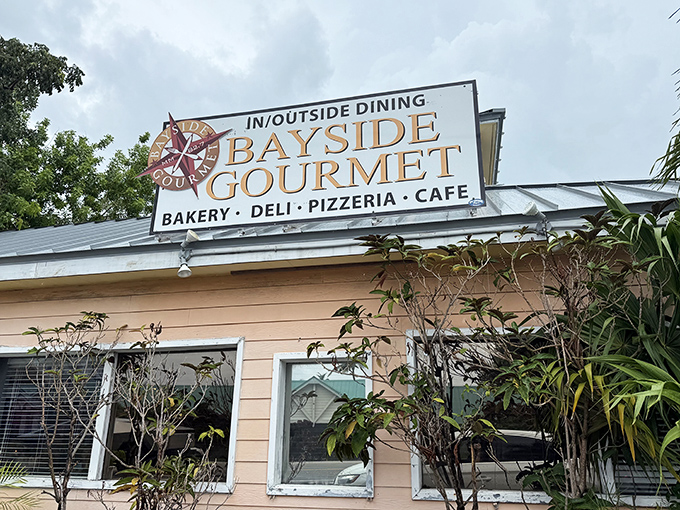 Bayside Gourmet proves paradise needs good pastries too. Their sign promises multiple ways to satisfy your cravings in one stop.