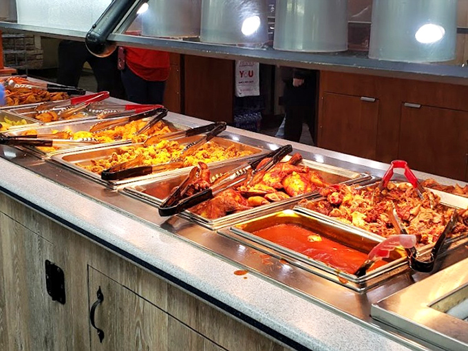 A buffet line that stretches like a highway of happiness, each steam tray promising a different delicious destination.