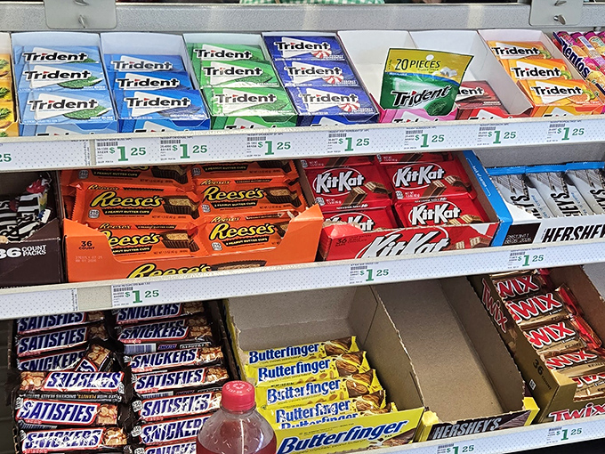 The candy aisle: where childhood nostalgia meets adult budgeting. Reese's, KitKat, and Butterfinger all lined up like old friends at a reunion.