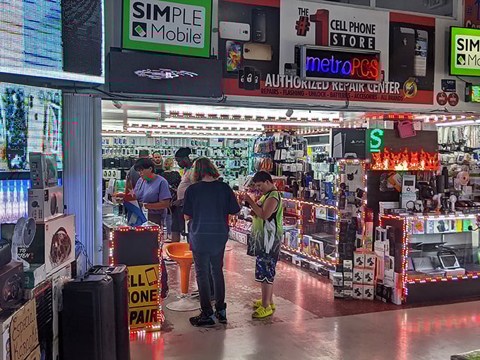 Tech paradise glows with neon promise. This cell phone repair and accessory hub proves the market isn't just about vintage finds &ndash; it's thoroughly plugged into modern needs.