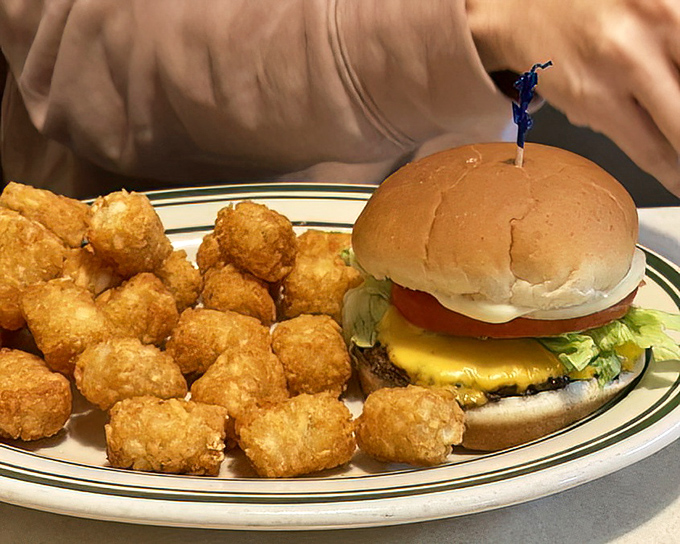 A cheeseburger with tater tot bodyguards. This plate doesn't care about your diet&mdash;it cares about your happiness.