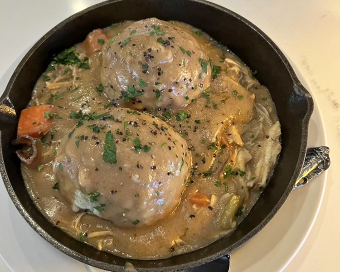 Chicken and dumplings that look like they floated straight out of a Southern grandmother's dream and into this cast iron skillet.