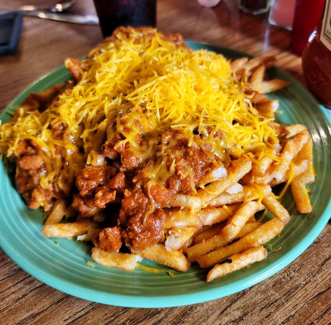 Chili cheese fries that don't know the meaning of moderation. That golden cheese blanket hides a treasure of savory chili that's worth every napkin.