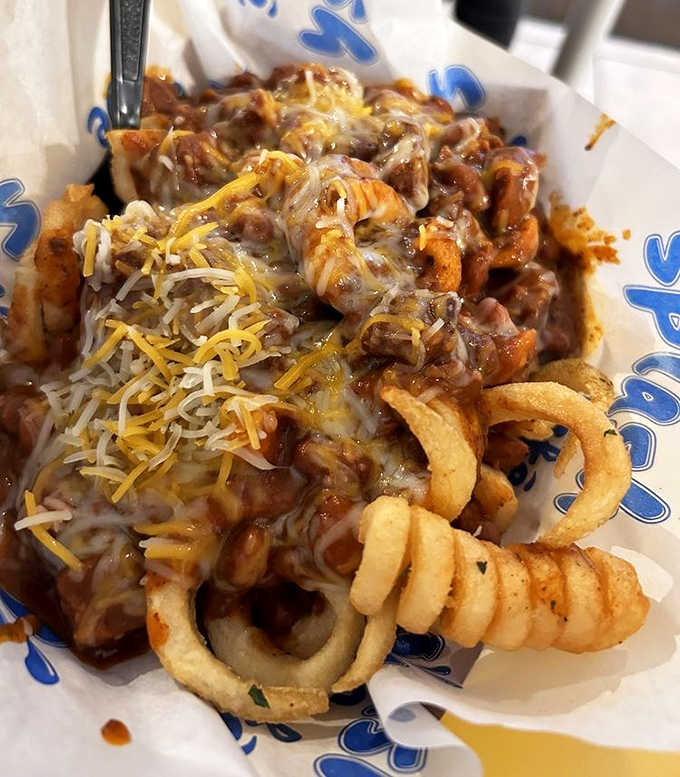 Chili cheese fries that laugh in the face of diet plans. A glorious mess of comfort that demands to be shared but rarely is.