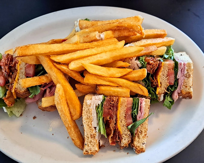 Club sandwich stacked so high it requires engineering skills and serious appetite to conquer this triple-decker beauty.