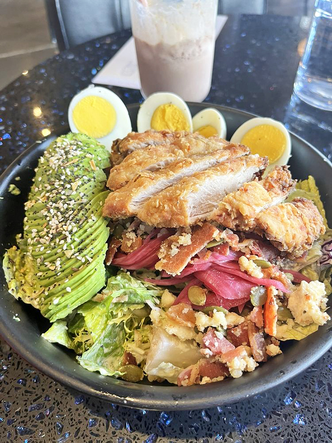 This isn't just a salad&mdash;it's a strategic arrangement of avocado, crispy chicken, and hard-boiled eggs that makes eating greens feel like a reward.