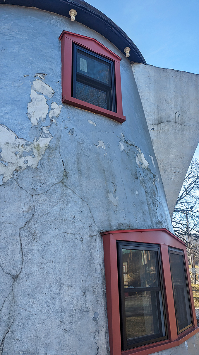 Red-trimmed windows punctuate the Coffee Pot's weathered exterior. Time has added character to this peculiar landmark, like wrinkles on a beloved face.