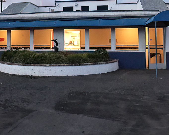 The clean, well-lit concession building stands ready for intermission rushes, when hundreds of moviegoers simultaneously crave nachos.