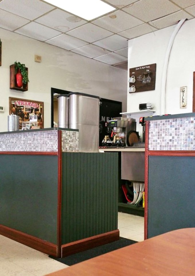 The heart of operations &ndash; where orders are called, coffee is poured, and the orchestrated dance of diner service happens with practiced precision.