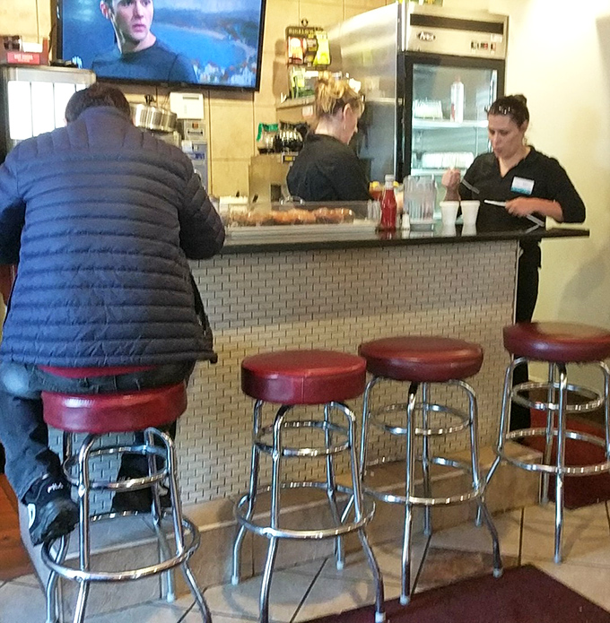 Classic diner counter seating &ndash; where solo diners find community and everyone gets a front-row view of short-order choreography.