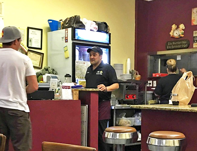The counter where regulars perch like birds on a wire, exchanging neighborhood news while waiting for their breakfast bounty.