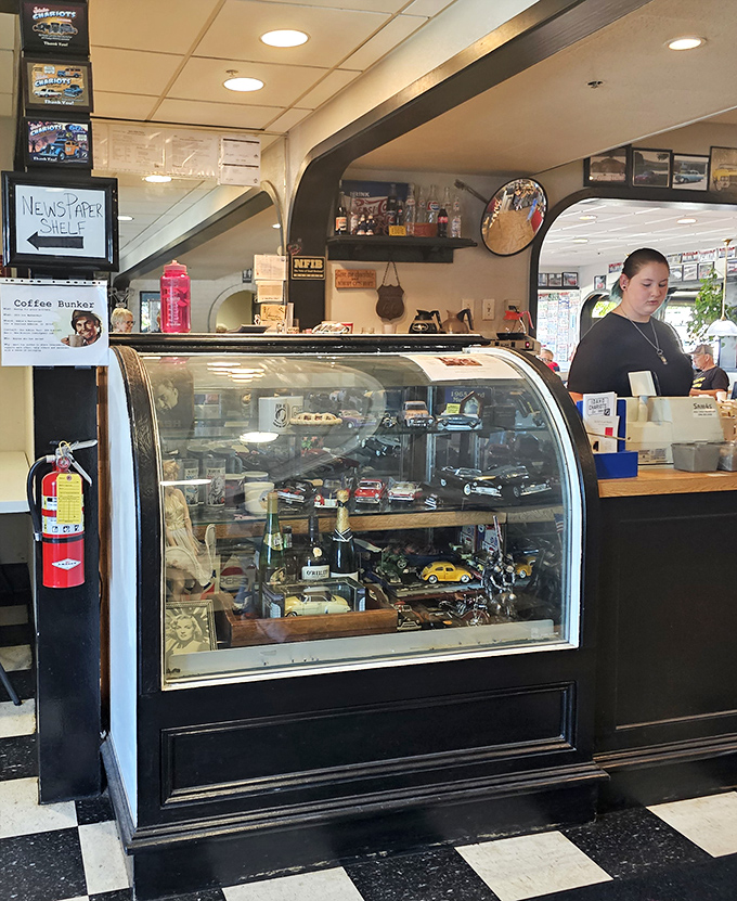 The display case holds treasures more valuable than gold – model cars and memorabilia that tell stories of Idaho's love affair with the open road.