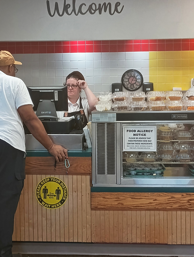 The cashier's station welcomes customers with colorful tiles and a reminder that some things, like good service, never go out of style.