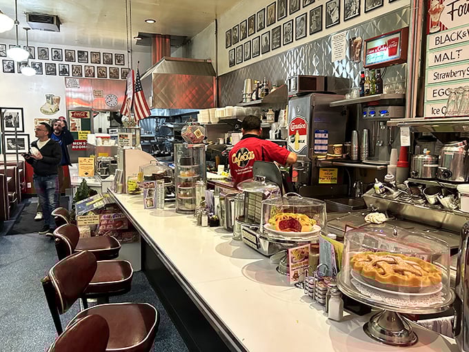The counter isn't just where food appears; it's theater-in-the-round where milkshake magicians and short-order wizards perform their delicious alchemy.