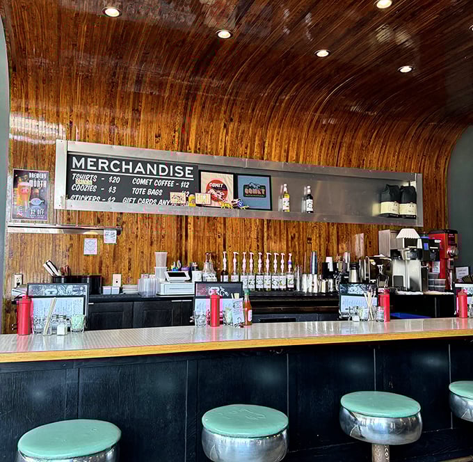 The mint-green counter stools against the wooden backdrop create a retro vibe that says, "Sit down, stay awhile, and order something indulgent."