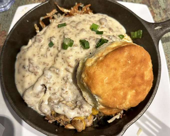 This country-style skillet with a golden biscuit perched atop is breakfast architecture at its finest &ndash; sturdy foundation, perfect proportions.