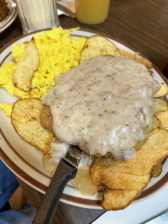 Country fried steak smothered in gravy with a side of sunshine-yellow eggs &ndash; cardiac concern meets comfort food paradise.