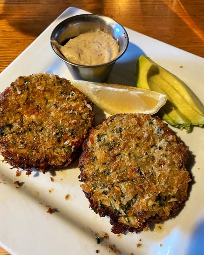 These crab cakes aren't just golden brown—they're the color of a perfect sunset, with a remoulade sauce that deserves its own fan club.