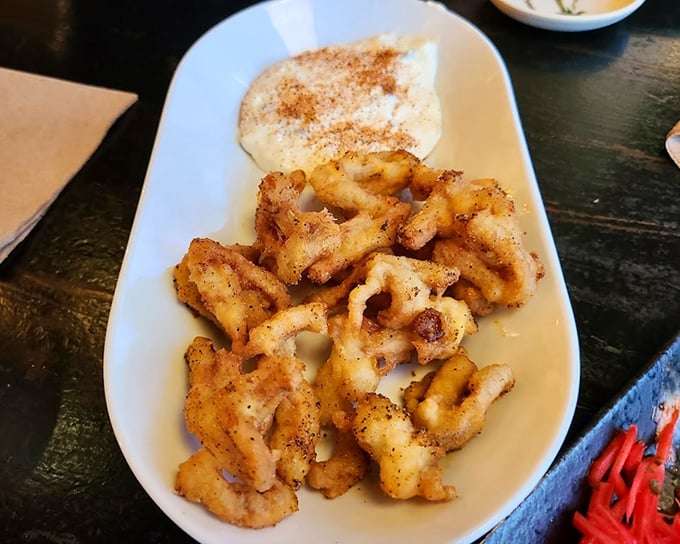 Crispy calamari that shatters with each bite, paired with a creamy dipping sauce that makes you wonder why you'd eat it any other way.