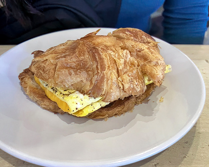 The humble croissant sandwich – where buttery layers cradle eggs and cheese in what can only be described as breakfast's perfect hug.