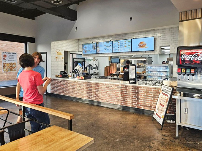 The ordering counter where chicken dreams come true. Clean lines, bright tiles, and the promise of comfort food just moments away.