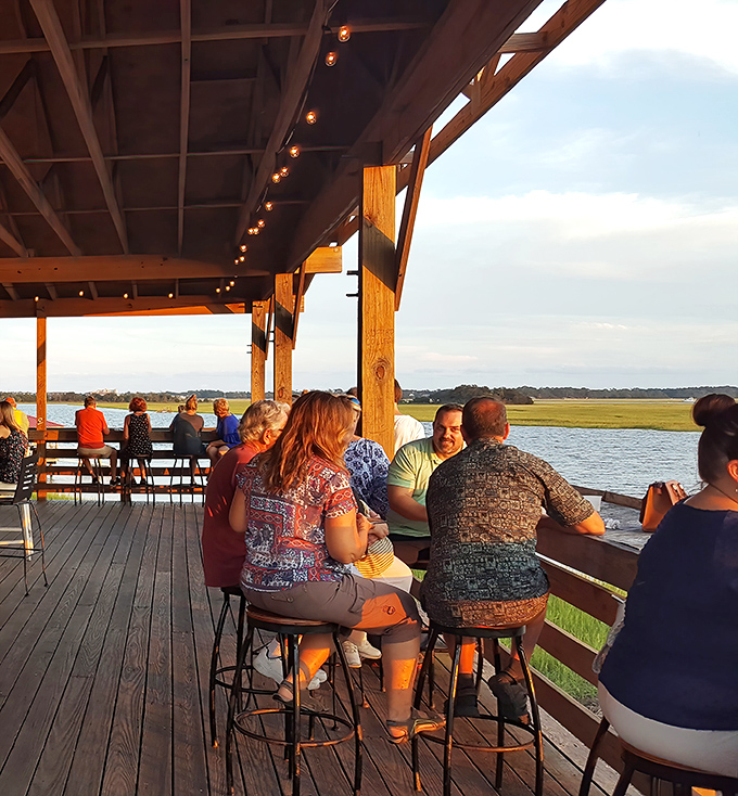 Sunset dining on the deck: where conversations flow as smoothly as the tidal waters stretching to the horizon.