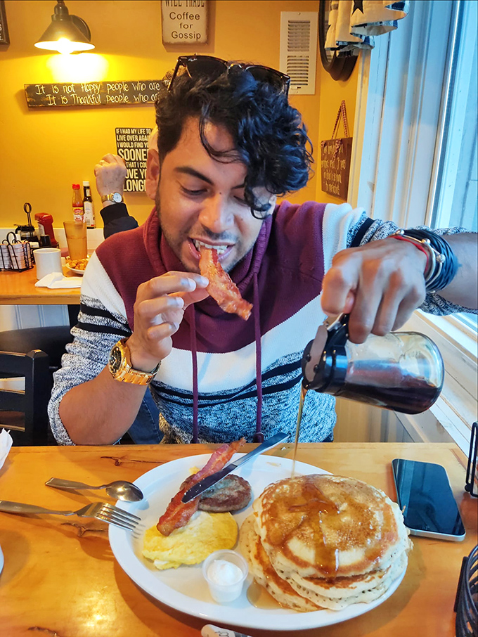 A patron enjoying the breakfast spread with childlike enthusiasm&mdash;because great diner food makes everyone feel like a kid again.