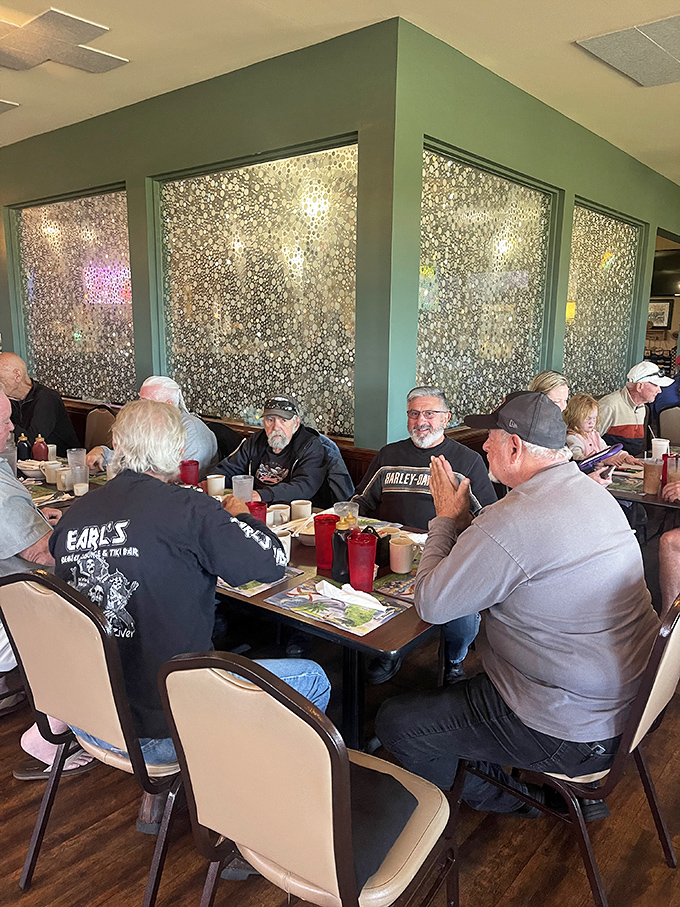 The breakfast club in session – locals gathering around tables, sharing stories and coffee in the warm glow of community and comfort food.