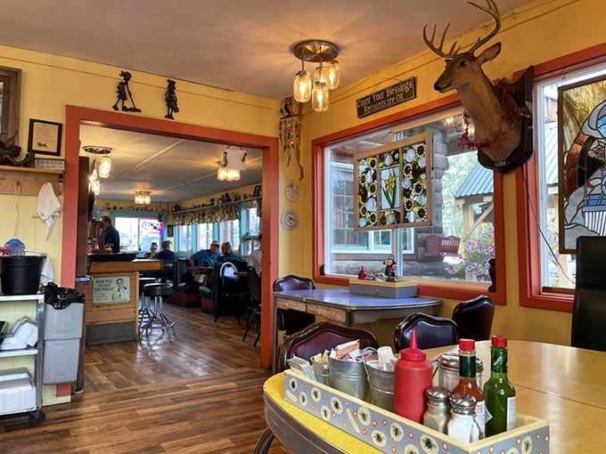 The mounted deer head watches over diners like a woodland guardian, while mason jar lights cast a warm glow that says "stay awhile, have another cup."