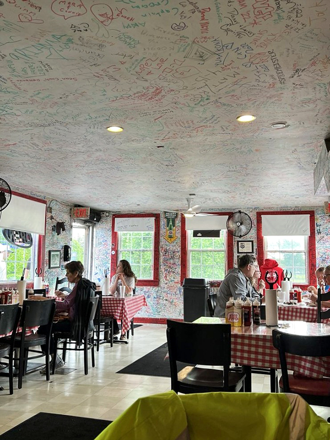 The dining room where strangers become friends over shared sauce recommendations. Those signatures on the walls? Each one represents a converted barbecue believer.
