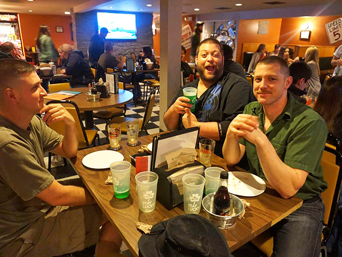 Nothing says "we found the good spot" like the genuine smiles of friends enjoying cold drinks and good company.