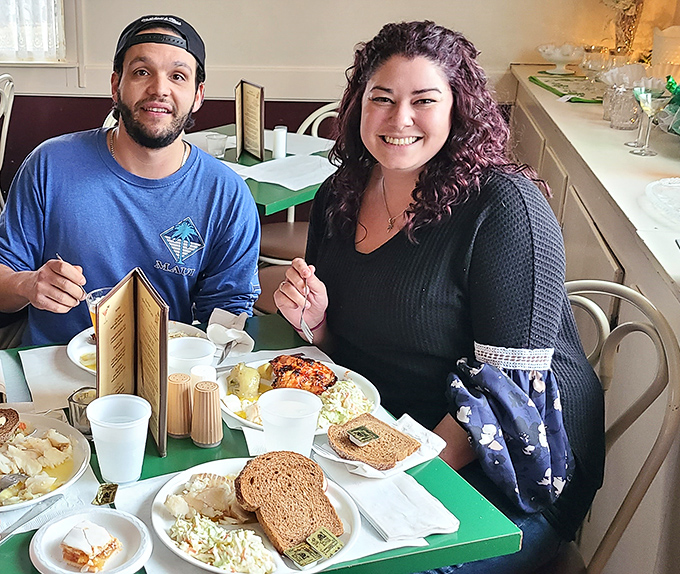 Happy diners caught mid-feast, surrounded by the evidence of Fitzgerald's generosity—plates loaded with comfort food classics and smiles that say it all.