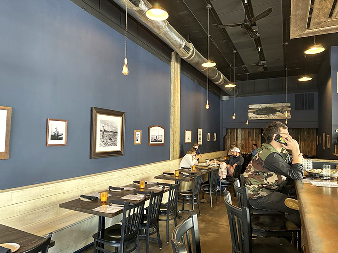 Navy blue walls create the perfect backdrop for seafood stories. The nautical-inspired dining room feels like the captain's quarters on a very stylish ship.