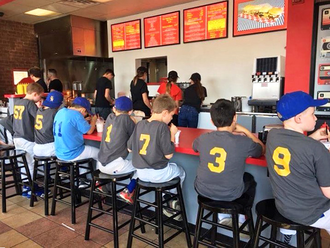 Little leaguers at the counter prove that burger appreciation starts young. Those numbered jerseys may change, but their burger orders probably won't.