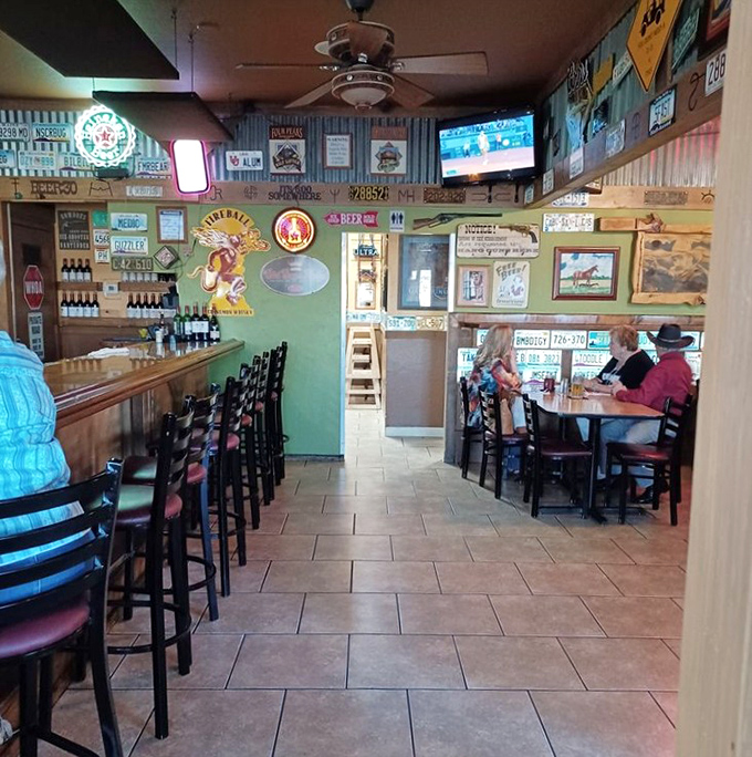 The bar area buzzes with local energy while license plates and western memorabilia create the backdrop for Arizona socializing.