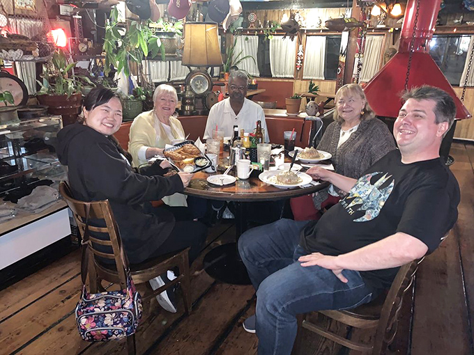 Happy diners gathered around a table laden with seafood treasures&mdash;the universal expression of "we found something special here" needs no translation.