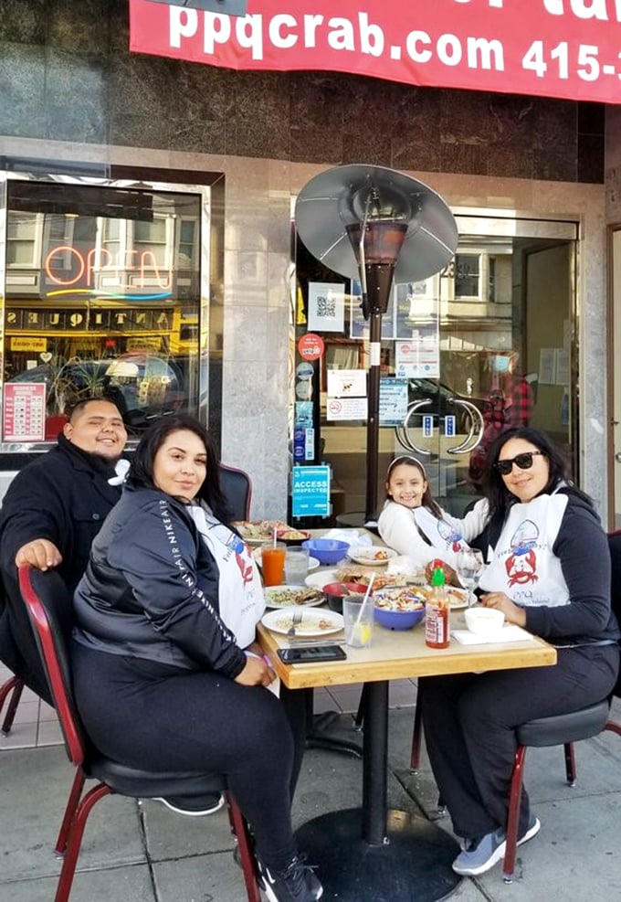 Happy diners sporting protective bibs&mdash;the universal uniform of serious crab enthusiasts who understand that deliciousness trumps dignity every time.
