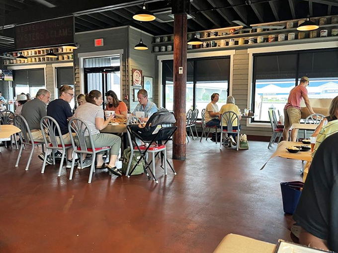 The dining room hums with the universal language of seafood enjoyment. Notice how nobody's looking at their phones&mdash;crab picking requires full attention and both hands.